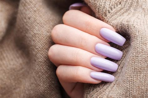 Premium Photo Girls Hands With A Soft Purple Manicure