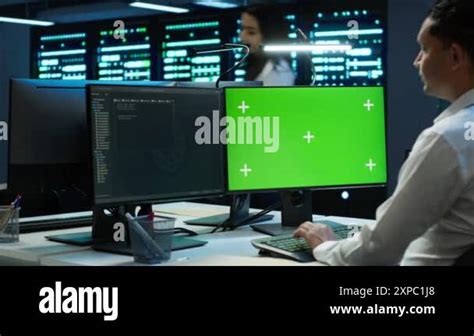 programmer in data center managing and maintaining databases using