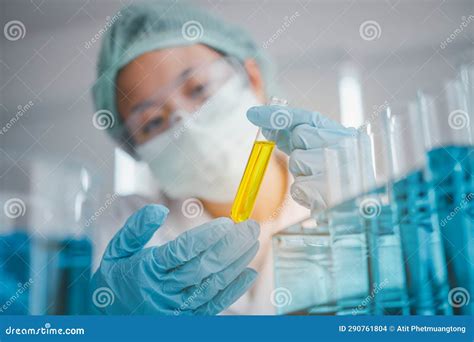 Female Researchers Are Experimenting With Pipette Dropping A Sample Into A Test Tube In An