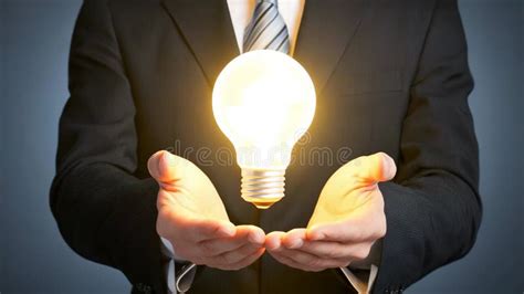 Businessman Holding Glowing Lightbulb With Radiation Symbol Signifying