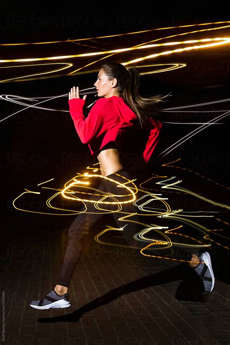 Woman Running In Flashing Lights By Stocksy Contributor Danil Nevsky Stocksy