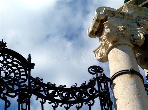 Closeup View Of Old Wrought Iron Ornamental Gate Detail White Stone