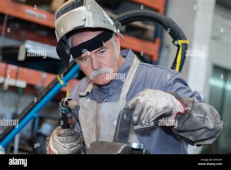 Senior Worker Using Gas Torch Stock Photo Alamy