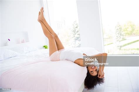 매력적인 사춘기 십 대의 초상화는 솔직 한 콘텐츠 바보 부주의 한 거짓말 침대 큰 빛 아파트 긍정적인 사랑 스러운 친절 한 다리를 물결 모양의 곱슬 헤어스타일 머리를 기쁘게