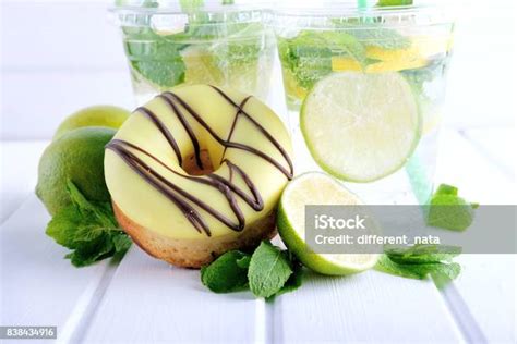 상쾌한 여름 음료입니다 녹색 빨 대와 플라스틱 칵테일 안경에 녹색 입힌 달콤한 도넛 라임과 민트 Mohito 0명에 대한 스톡 사진 및 기타 이미지 Istock