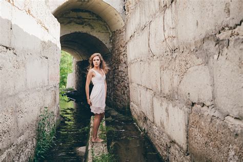 하얀 드레스에 곱슬 자연 머리와 아름 다운 행복 한 소녀는 터널에서 춤을 여름 아름다움 초상화입니다 꿈꾸는 여자는 자연을 즐길