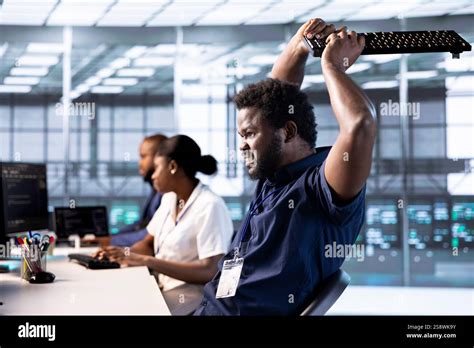 Mad Software Developer In Data Center Smashing Keyboard After
