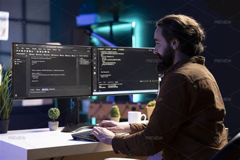Happy Developer In Apartment Writing Lines Of Binary Code On Computer