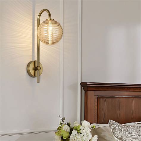 Lumiere Tenterden Curved Arm Ip44 Wall Light In Brass Gold With Ribbed Round Amber Glass Diffuser