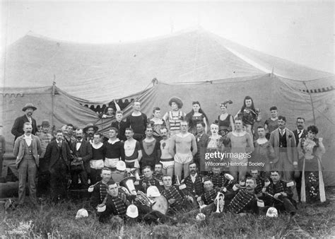 A Large Group Of Circus Performers And Personnel Including A Clown