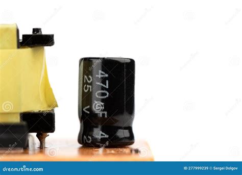 Close Up Of A Black 470 F Capacitor Soldered Into A Circuit Board