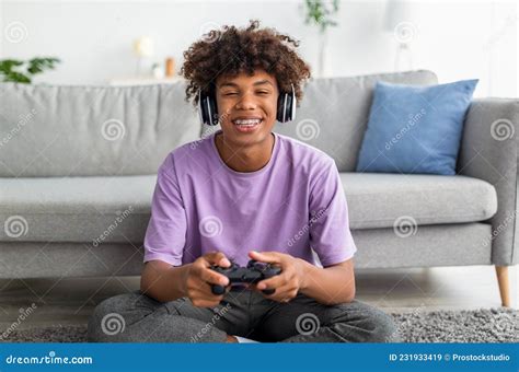 Portrait Of Cool Black Teen Gamer With Controller Playing Online Video