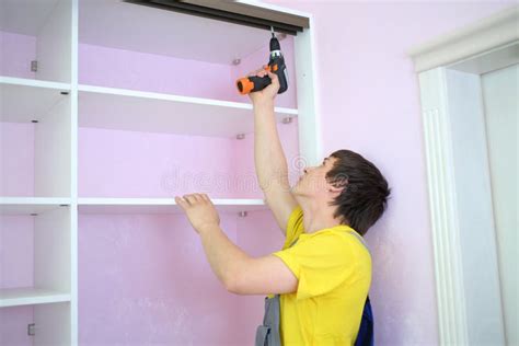 man installing guide rails for sliding wardrobe in stock image image of assembly fastening