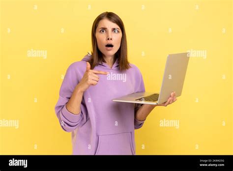 Portrait Of Amazed Shocked Young Adult Woman Working On Laptop Compute