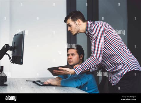 Two Young It Programmers Coding Working On A Joint Project In The