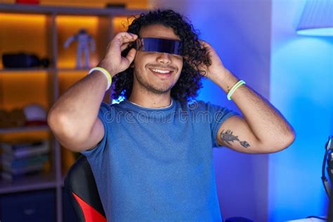 Young Latin Man Streamer Playing Video Game Using Virtual Reality