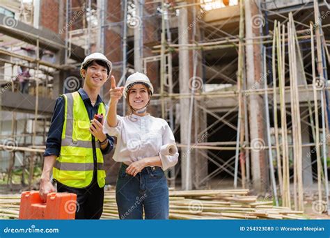 Structural Engineer And Architect Discussing And Working With