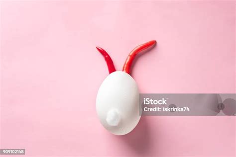 계란 껍질과 레드 핫 칠리 페 퍼 인조 토끼 핑크 컬러 배경 종이에 악마 광대의 얼굴을 토끼 음식 개념 최소한의 부활절 할로윈 4월에 대한 스톡 사진 및 기타 이미지