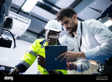 Technicians Are Introducing Industrial Hand Robots To Businessperson Of