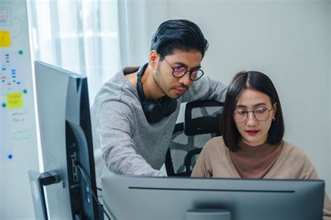 Asian And Indian Developer Team Discussion Feedback Analysis Coding Data With Software Computer