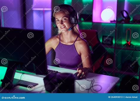 Young Blonde Woman Streamer Playing Video Game Using Computer At Gaming