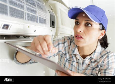 Female Worker Confirms Issue With Air Conditioning Stock Photo Alamy