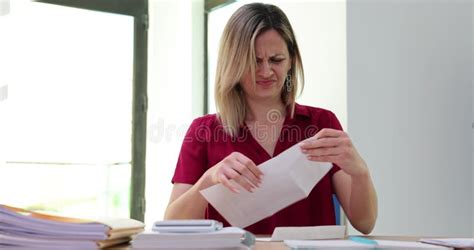 Blonde Woman Opens Letter And Becomes Outraged By Content Stock Footage