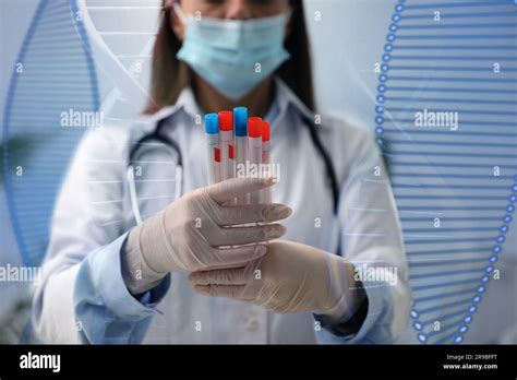 Genetic Testing Laboratory Worker With Test Tubes And Illustration Of