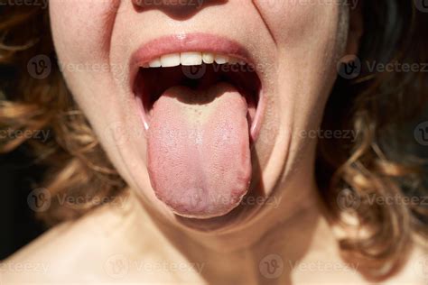 Close Up Of Caucasian Female With Open Mouth And Extended Tongue In
