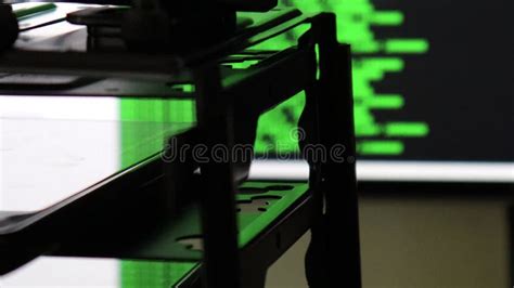 green computer software code moving on a black monitor reflect on glass