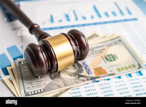 gavel for judge lawyer with us dollar banknotes on chart graph paper finance concept stock