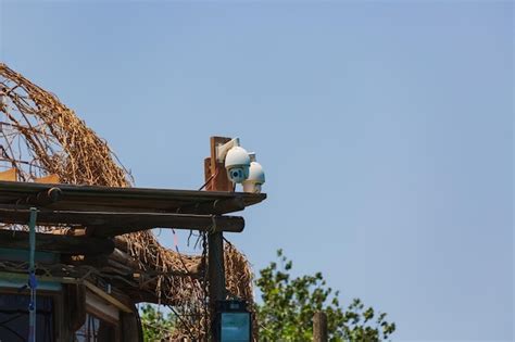 Premium Photo White Surveillance Camera Installed On A Wooden Structure A Portion Of The