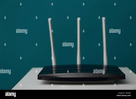 Modern Wi Fi Router On Light Table Against Color Background Stock Photo Alamy