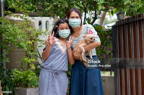아시아 의 어머니와 아이는 마스크를 착용하고 자연 공원에서 함께 개와 함께 놀고있습니다 태국 여성과 Dauther 인사와 집에서 포옹 행복한 가족 개념 10 11세에 대한