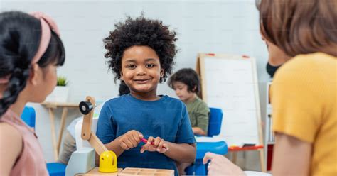 아시아의 아름다운 젊은 여성 교사가 학교에서 아이에게 수업을 가르치고 있다 매력적인 여성 강사 마스터가 유치원 교실에서 재미있는 활동으로 어린이 학생을 설명하고 교육합니다
