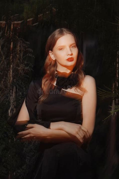 Female Model Illuminated By A Light Source Against A Background Of Foliage Stock Image Image