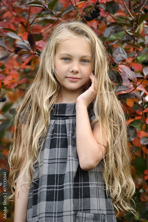 Beautiful Blonde Girl With Long Hair Against The Background Of Autumn