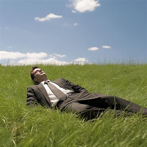 A Man In A Suit Laying In The Grass Premium Ai Generated Image