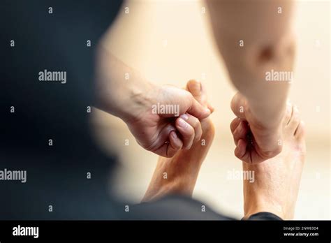Yogini Doing Forward Bending Exercise On The Floor Reaching Foot And