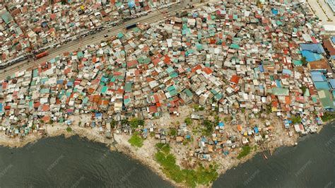 Premium Photo Slums In Manila Near The Port River Polluted With