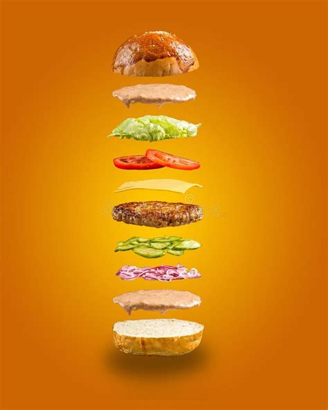 Floating Burger Ingredients On The Yellow Background Stock Image
