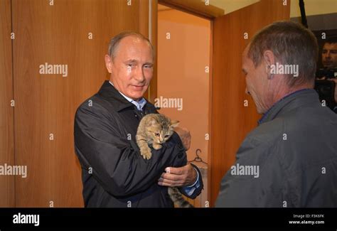 Russian President Vladimir Putin Holds A Cat As He Inspects Housing