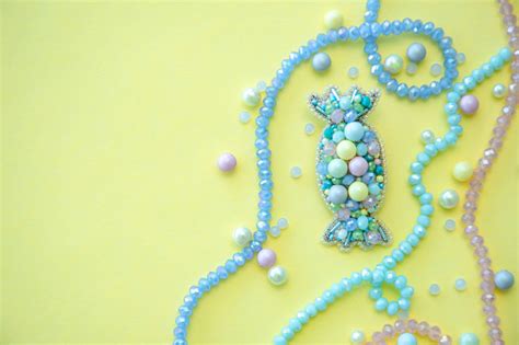 파스텔 색상의 수제 사탕 브로치 패션 쥬얼리 복사 공간 구슬 진주와 크리스탈 플랫 누워 노란색 배경에 소녀와 여성 액세서리 0