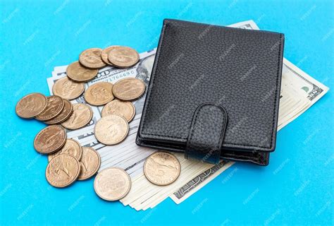 Premium Photo Wallet With Dollar Bills And Coins On Blue Background