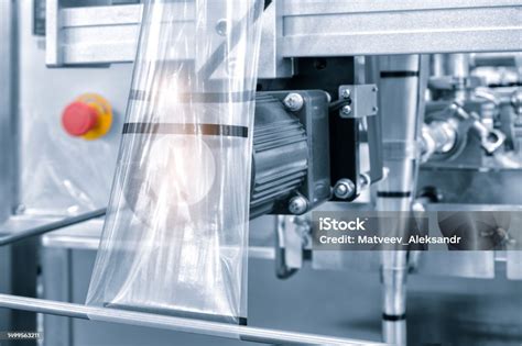 제품 및 식품의 조명 효과가 있는 플라스틱 포장용 자동 산업 기계 하늘색 장면에 있는 플레스틱 필름을 가진 자동화한 포장 라인