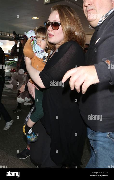 Adele Arrives At Los Angeles International Lax Airport Carrying Her