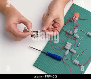 Babe S Hands Attaching Wires From Connectors To Terminals Of Variable Resistor Building A Radio