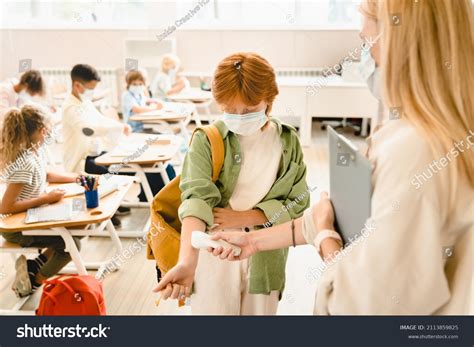 Teacher Measuring Temperature On Babegirls Wrist Stock Photo Shutterstock