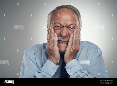 I Shouldnt Have Done That A Senior Businessman Standing Against A Grey