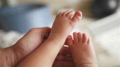 Baby Feet Close Up Dad Holds A Baby Daughter Legs In Hands Close Up Indoors Happy Family Kid
